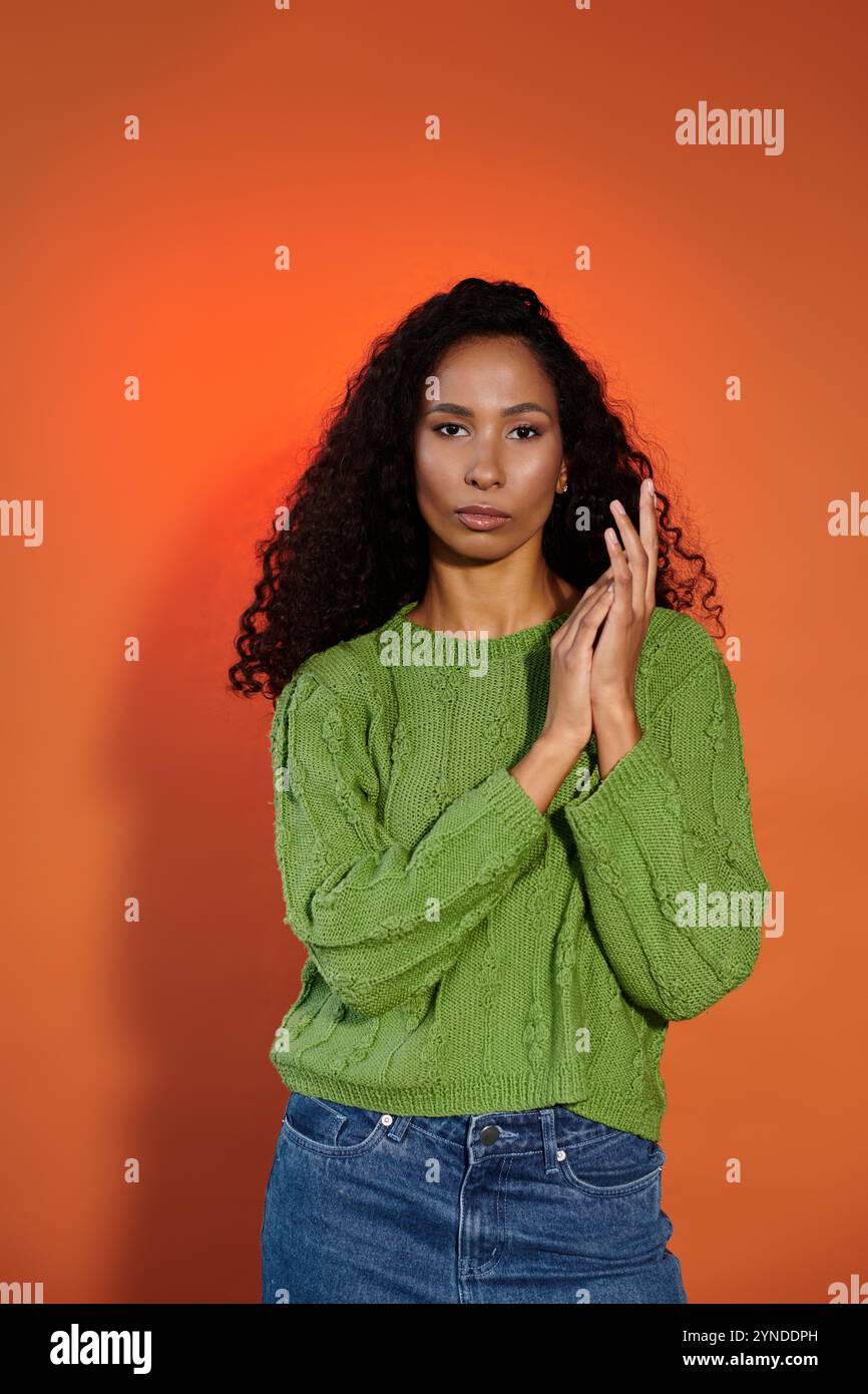 The woman in the green sweater catches the eye against a vibrant orange ...