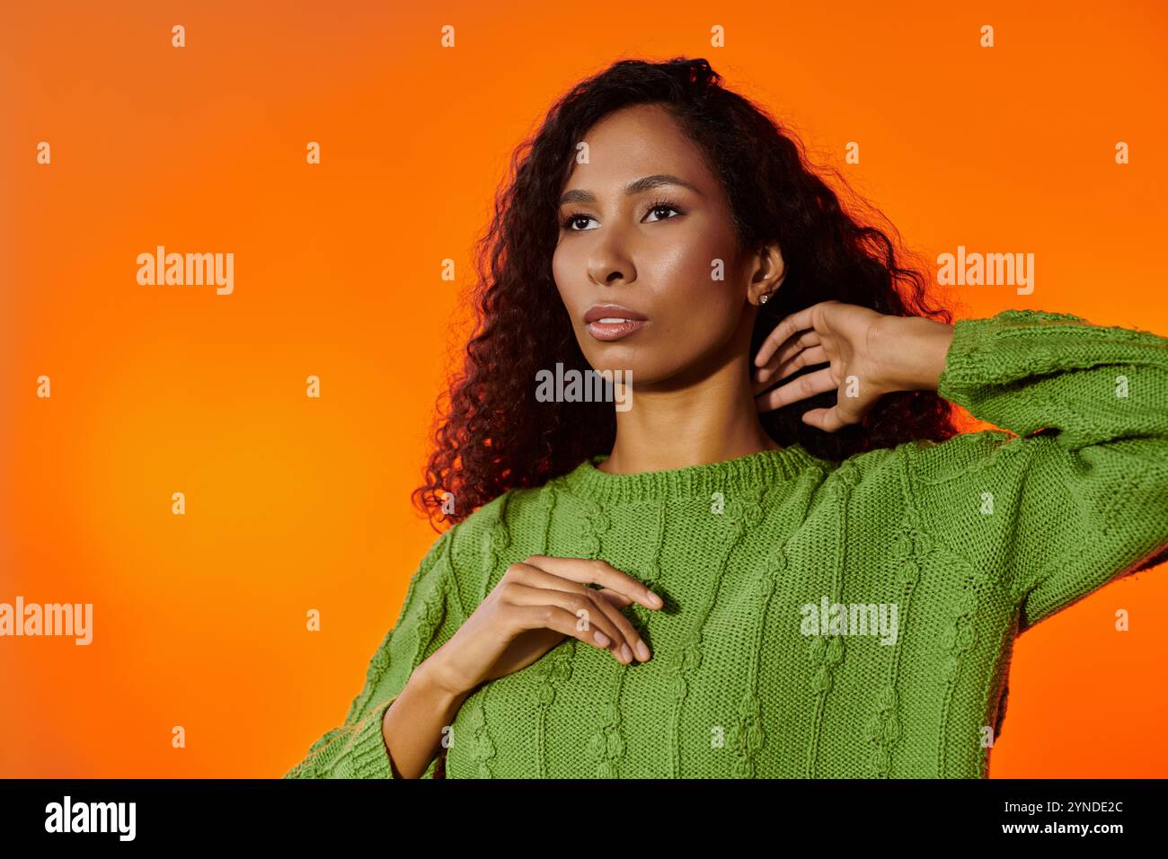 Striking woman poses thoughtfully, showcasing her natural beauty amidst ...