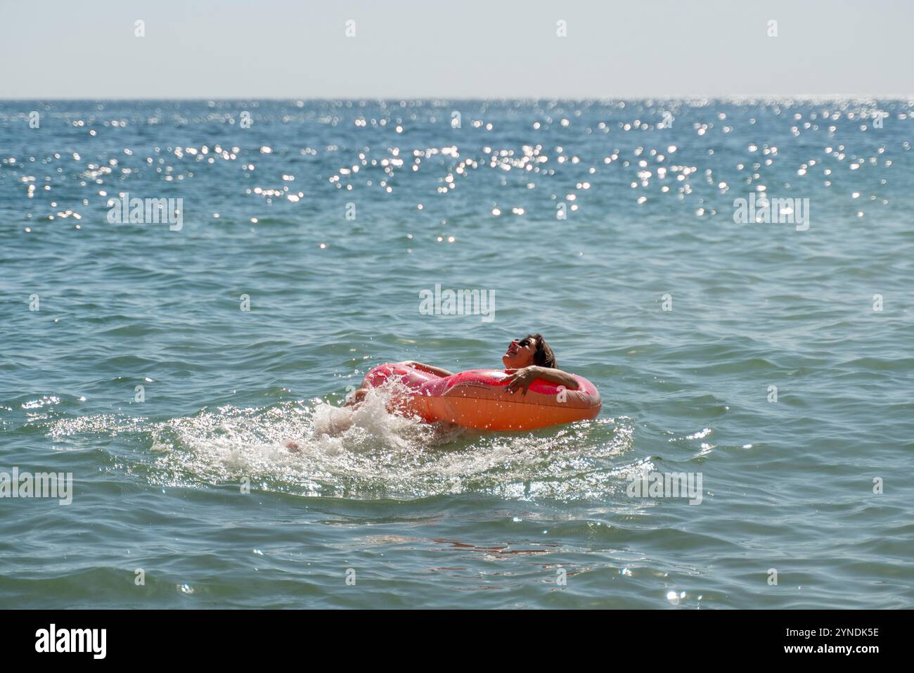 Woman Inflatable Raft Ocean - A woman relaxes and floats on an ...
