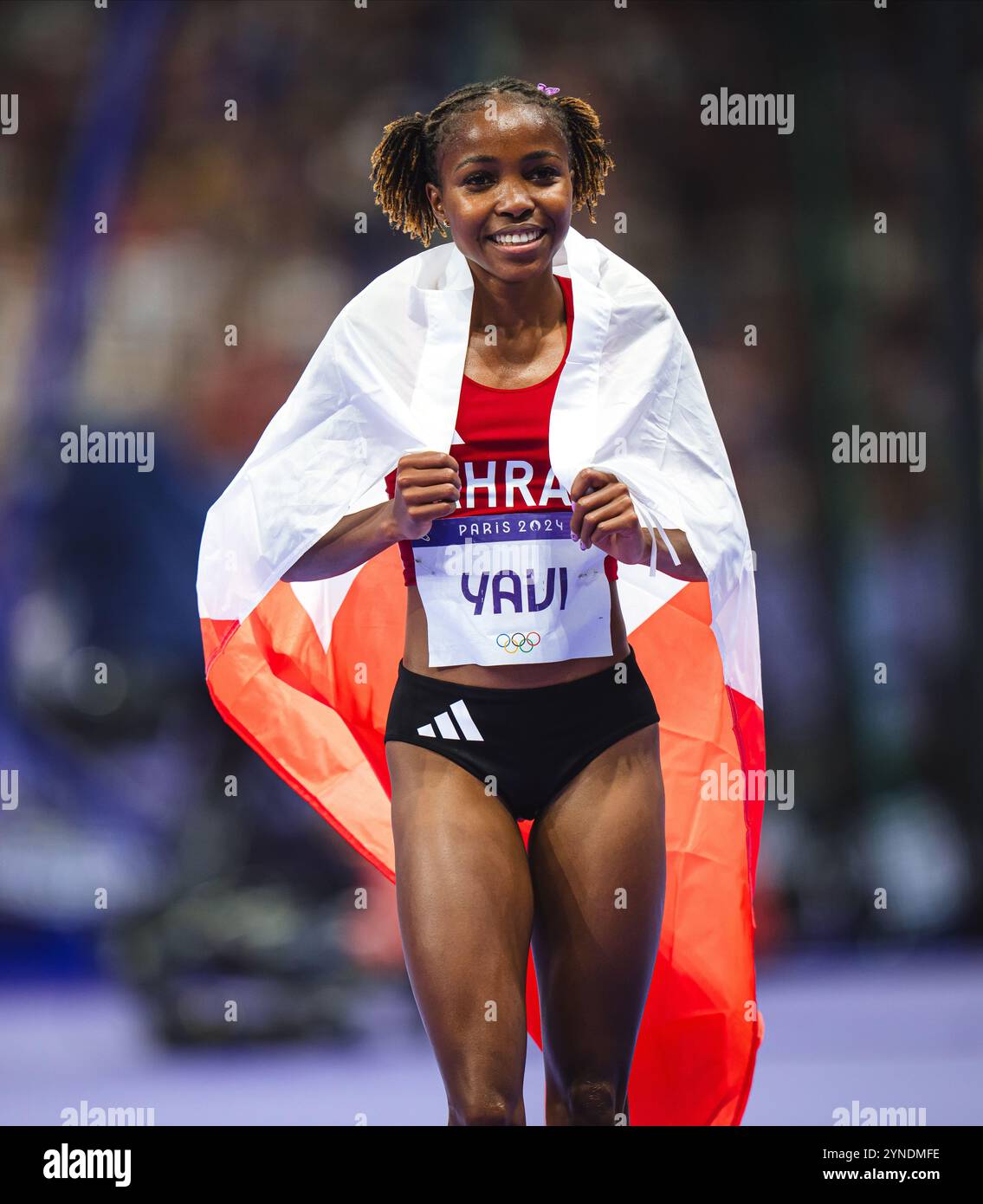 Winfred Yavi celebrating her medal with her country's flag at the Paris ...