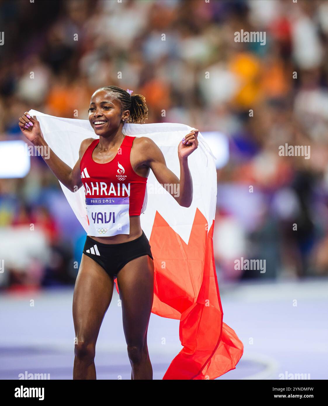 Winfred Yavi celebrating her medal with her country's flag at the Paris ...