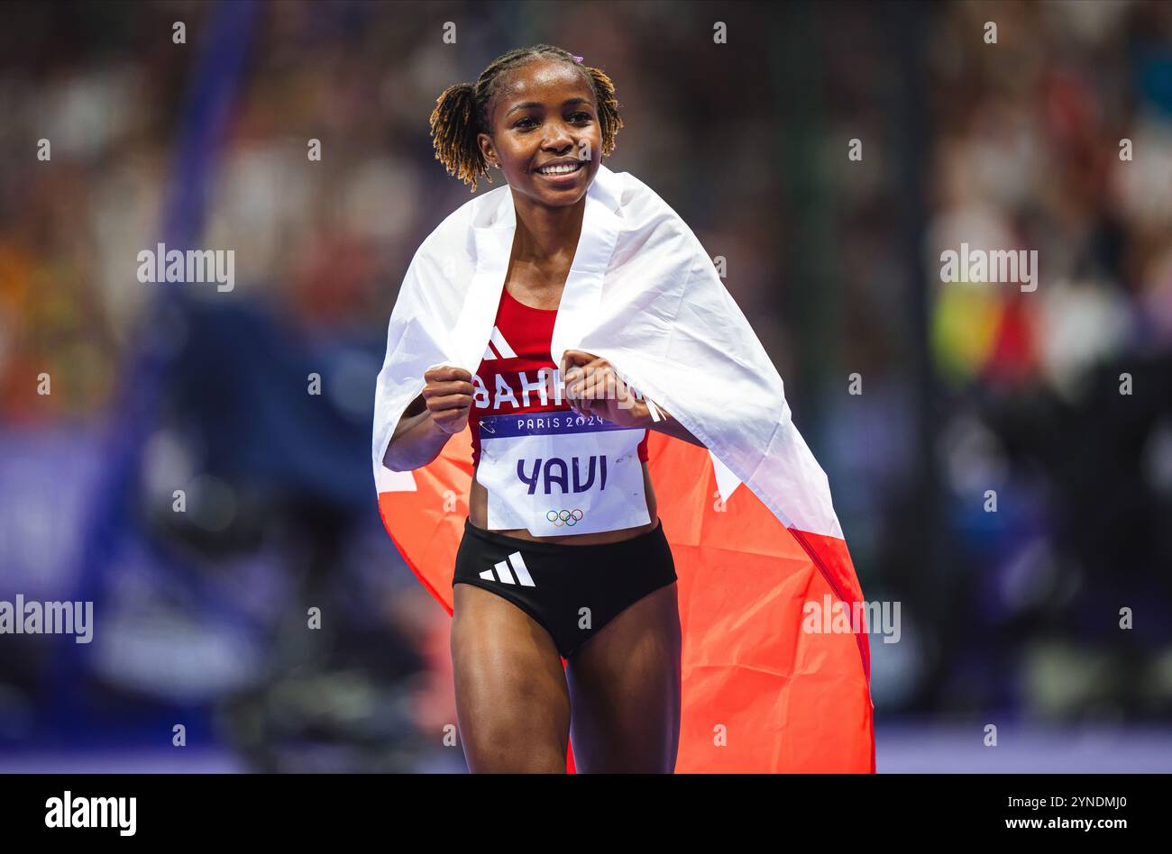 Winfred Yavi celebrating her medal with her country's flag at the Paris ...