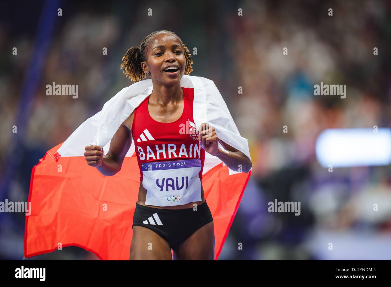 Winfred Yavi celebrating her medal with her country's flag at the Paris ...