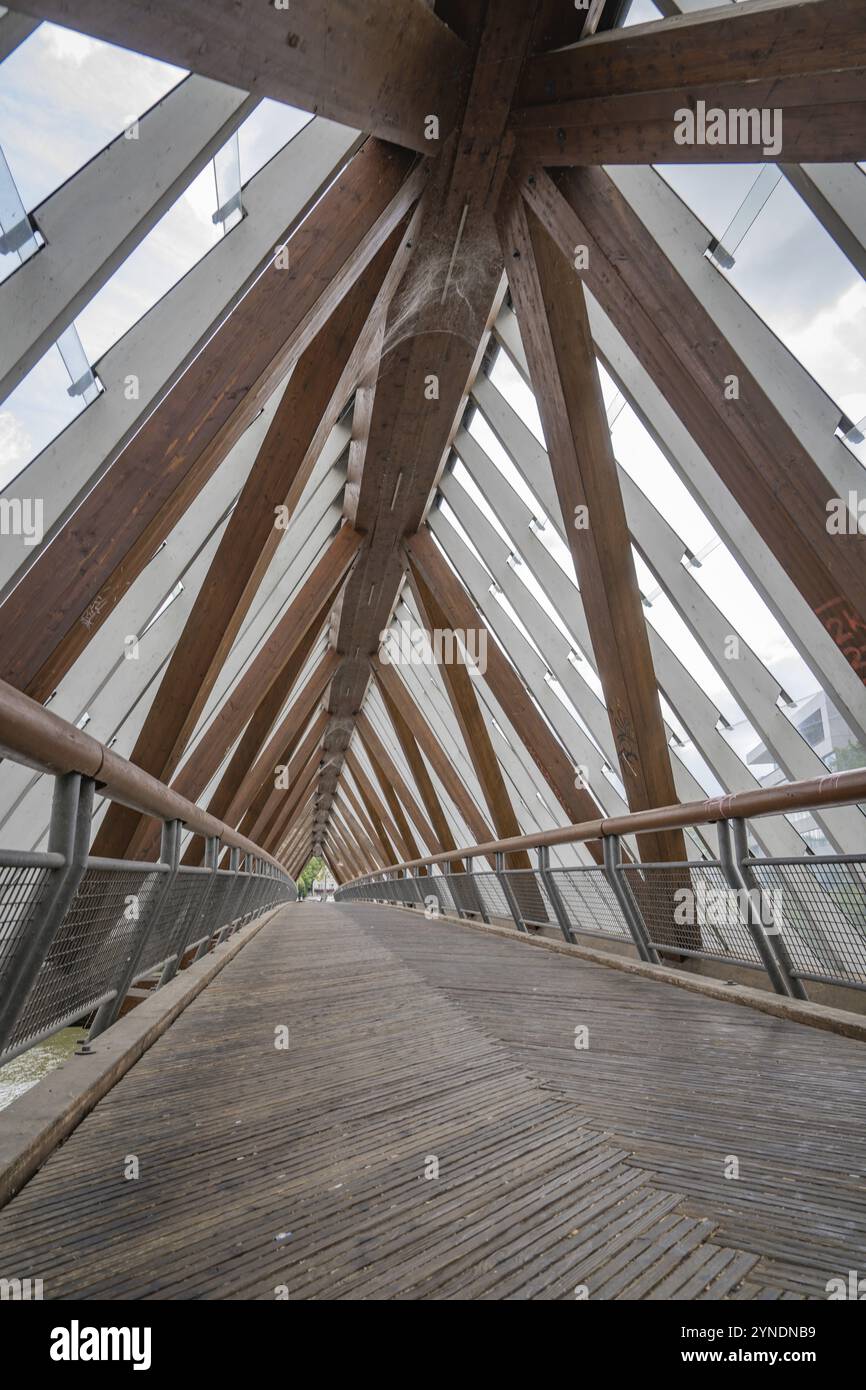 Wooden bridge with glass roofing in symmetrical design Stock Photo - Alamy