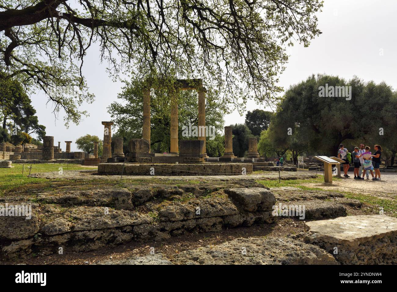 Tourist group at the Philippeion, restored ruins, rotunda, ancient ...