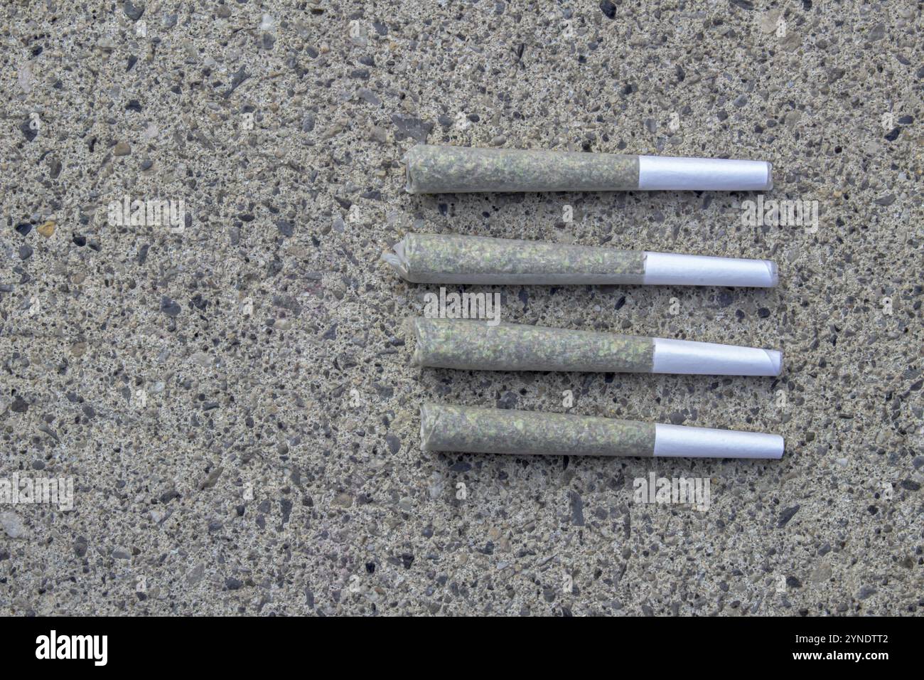 Pre-Rolls Cannabis Joints and dried flower marijuana on a concrete ...