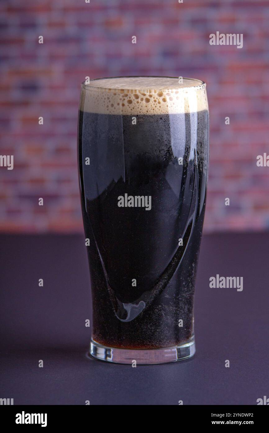 A Guinness dark Irish dry stout beer glass that originated in the ...