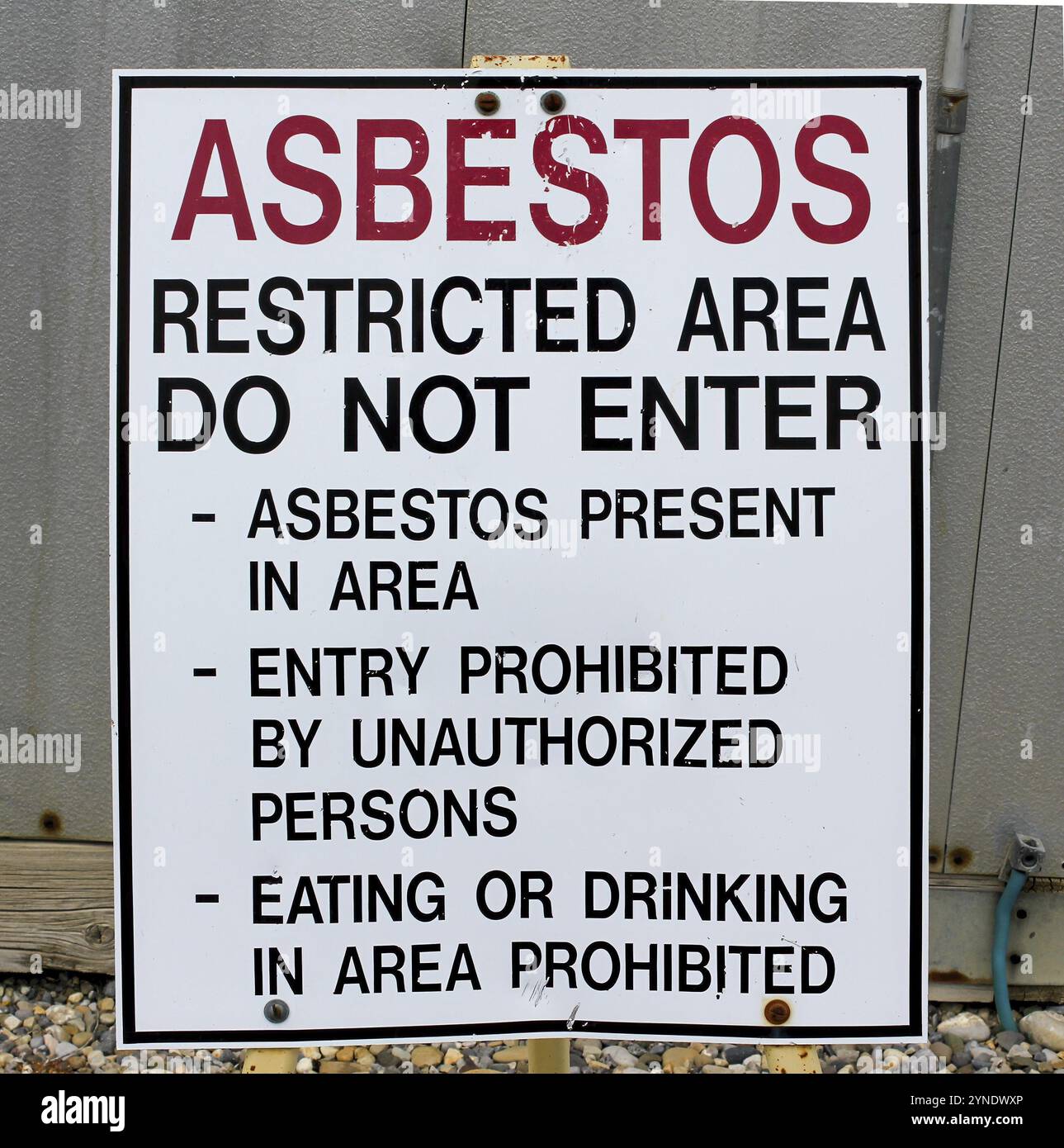 A warning sign at a gas industrial facility with the message: Asbestos ...