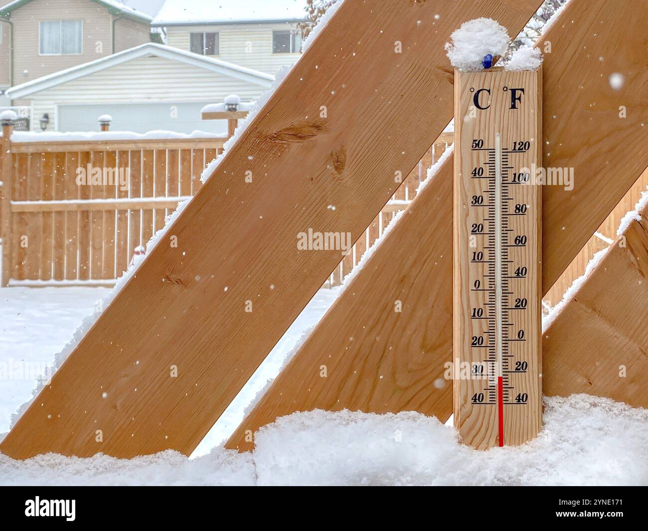 A Thermometer on a snow fall with a cold temperature Stock Photo - Alamy