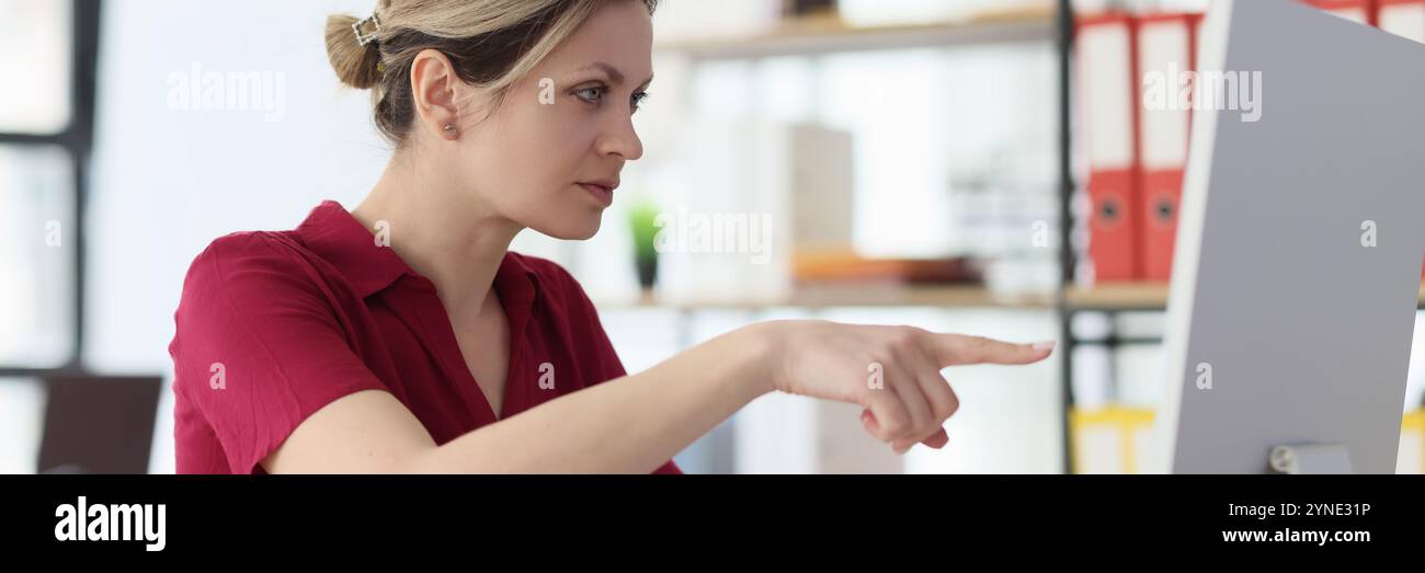 Woman points finger computer screen hi-res stock photography and images ...