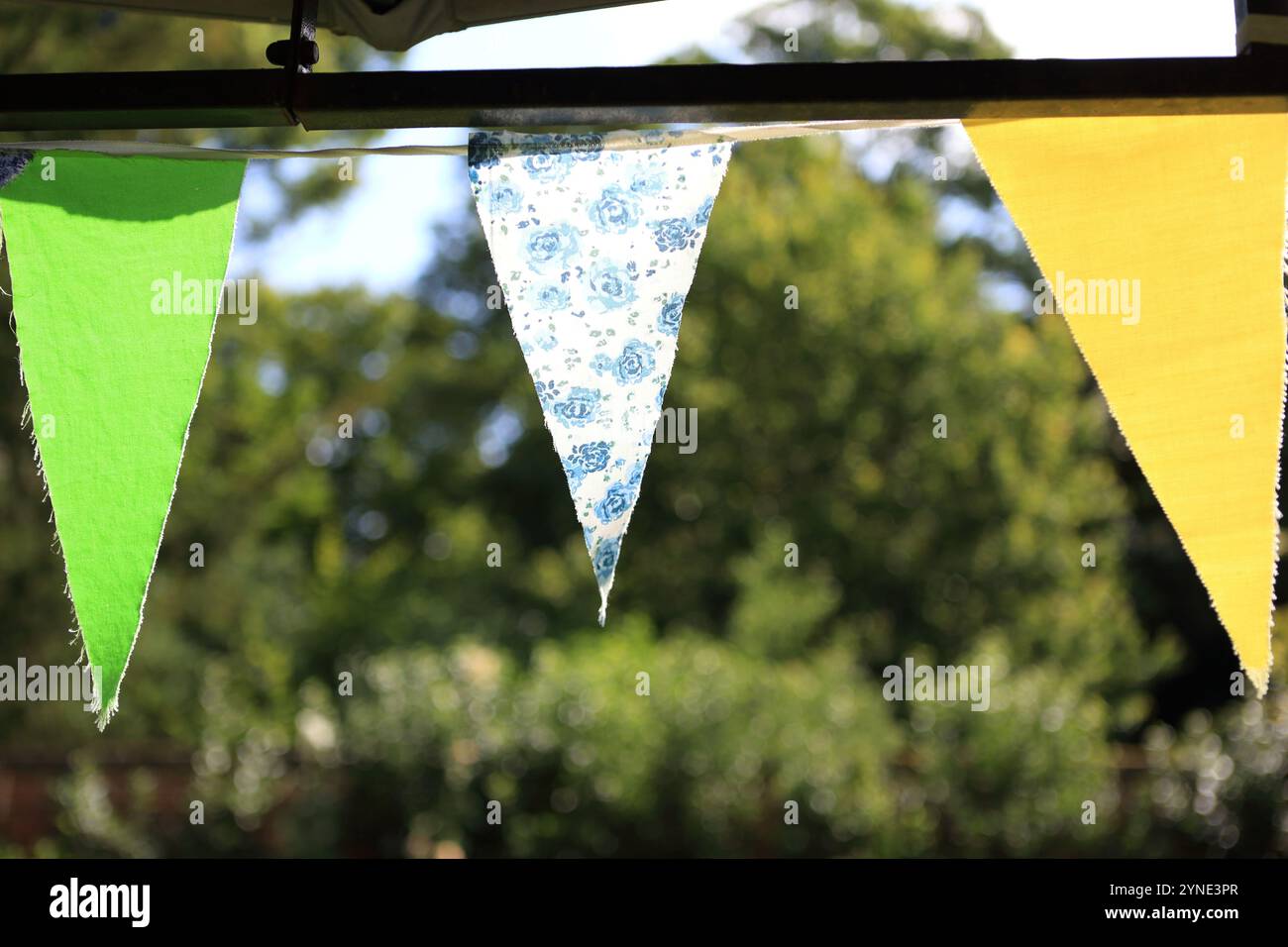 Triangular bunting made from fabric hanging in front of green ...