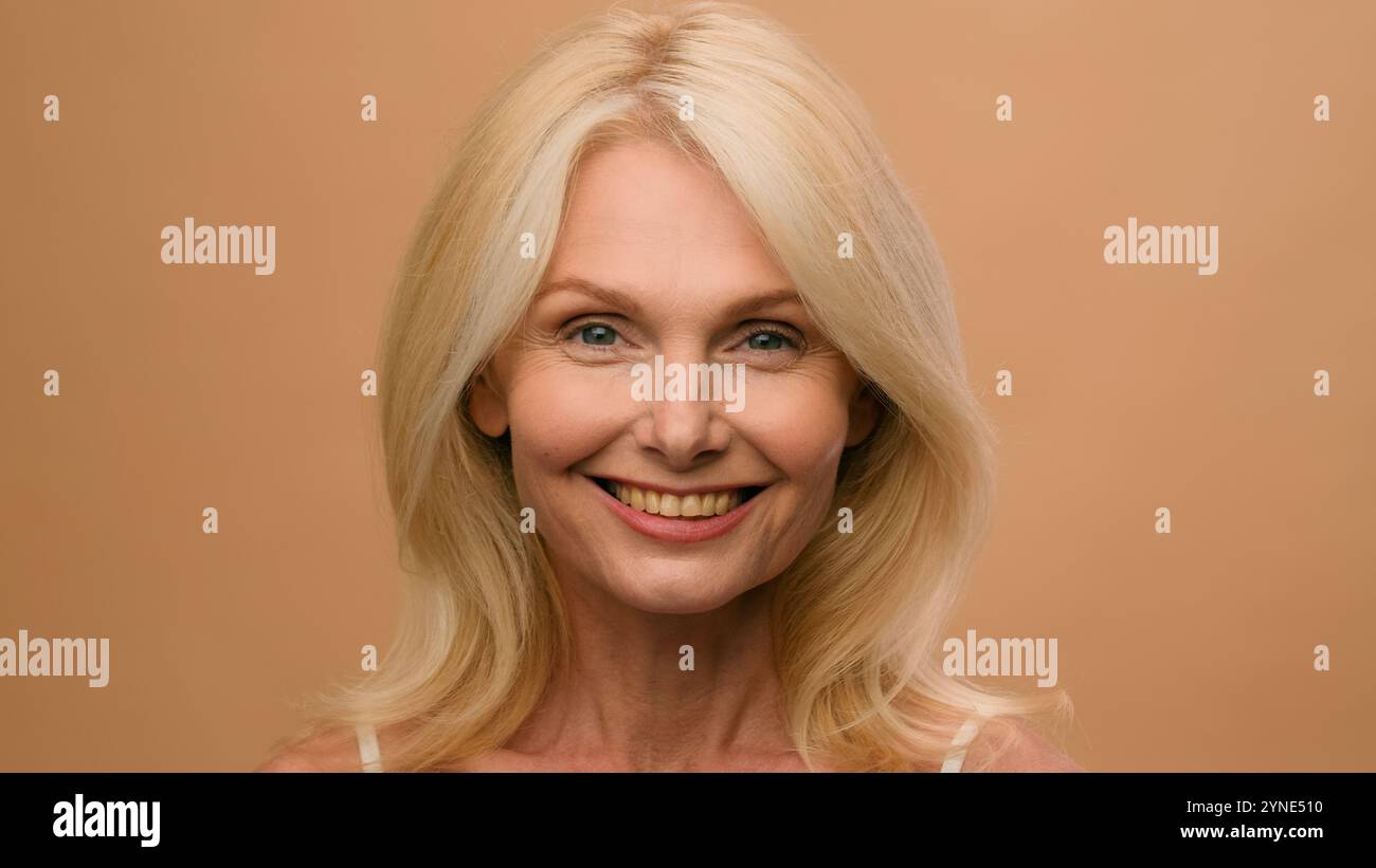 Close up beautiful Caucasian senior mature woman smiling mid aged 50s ...