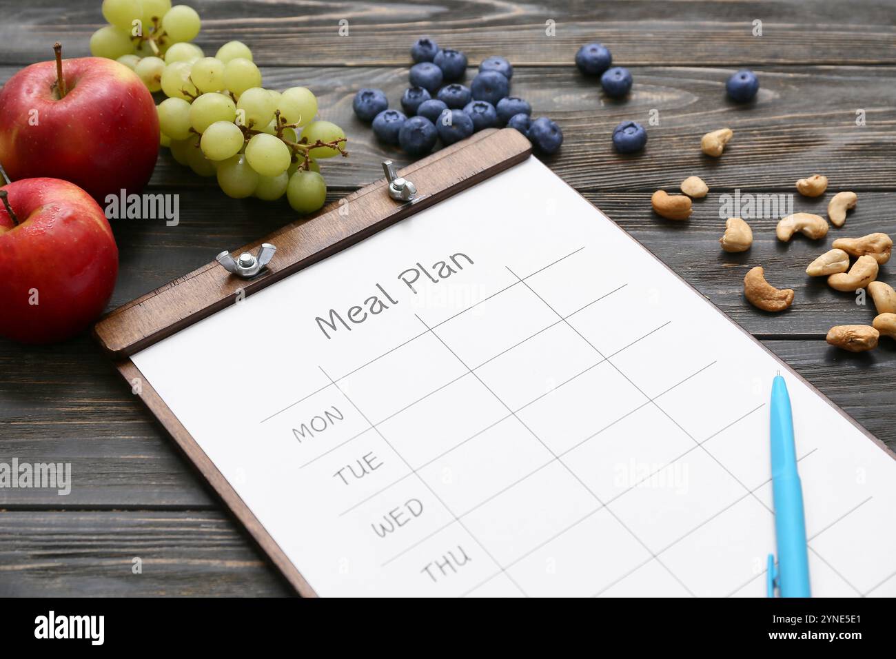 Healthy products and weekly meal plan on wooden background. Diet ...