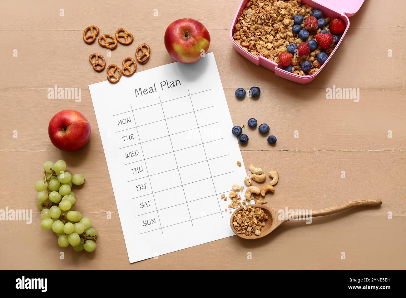 Healthy products and weekly meal plan on beige wooden background. Diet ...