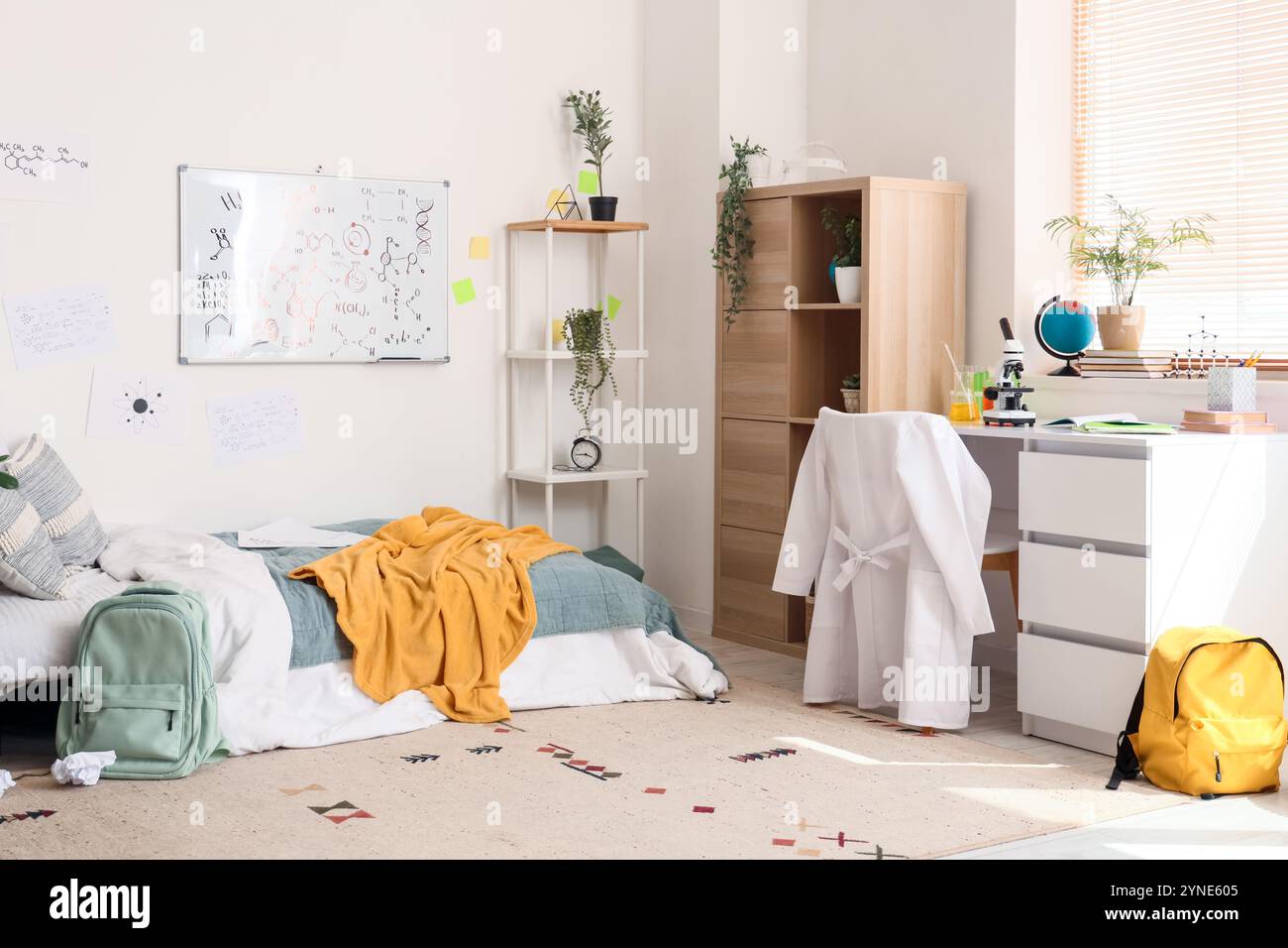 Interior of messy teenager's room with modern microscope and chemical ...