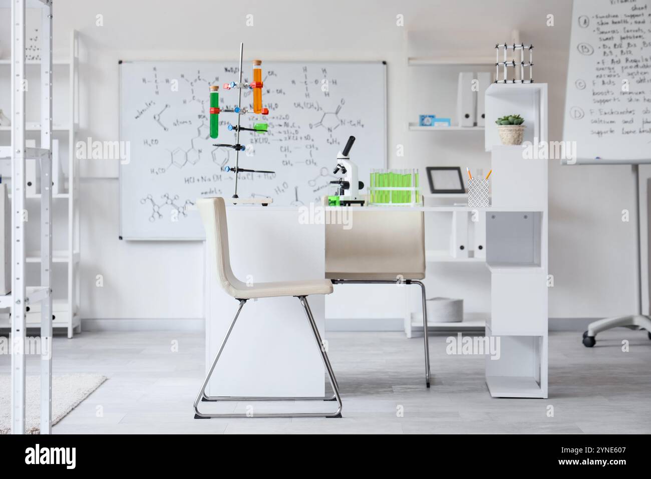 Interior of laboratory with workplace, shelf units and chemical ...