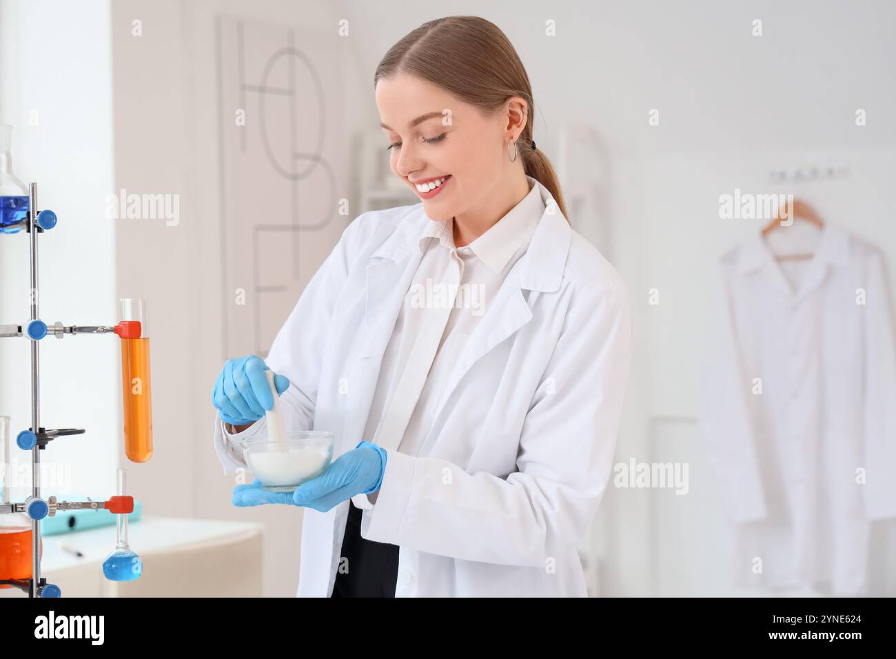 Female chemist grinding powder in laboratory Stock Photo - Alamy