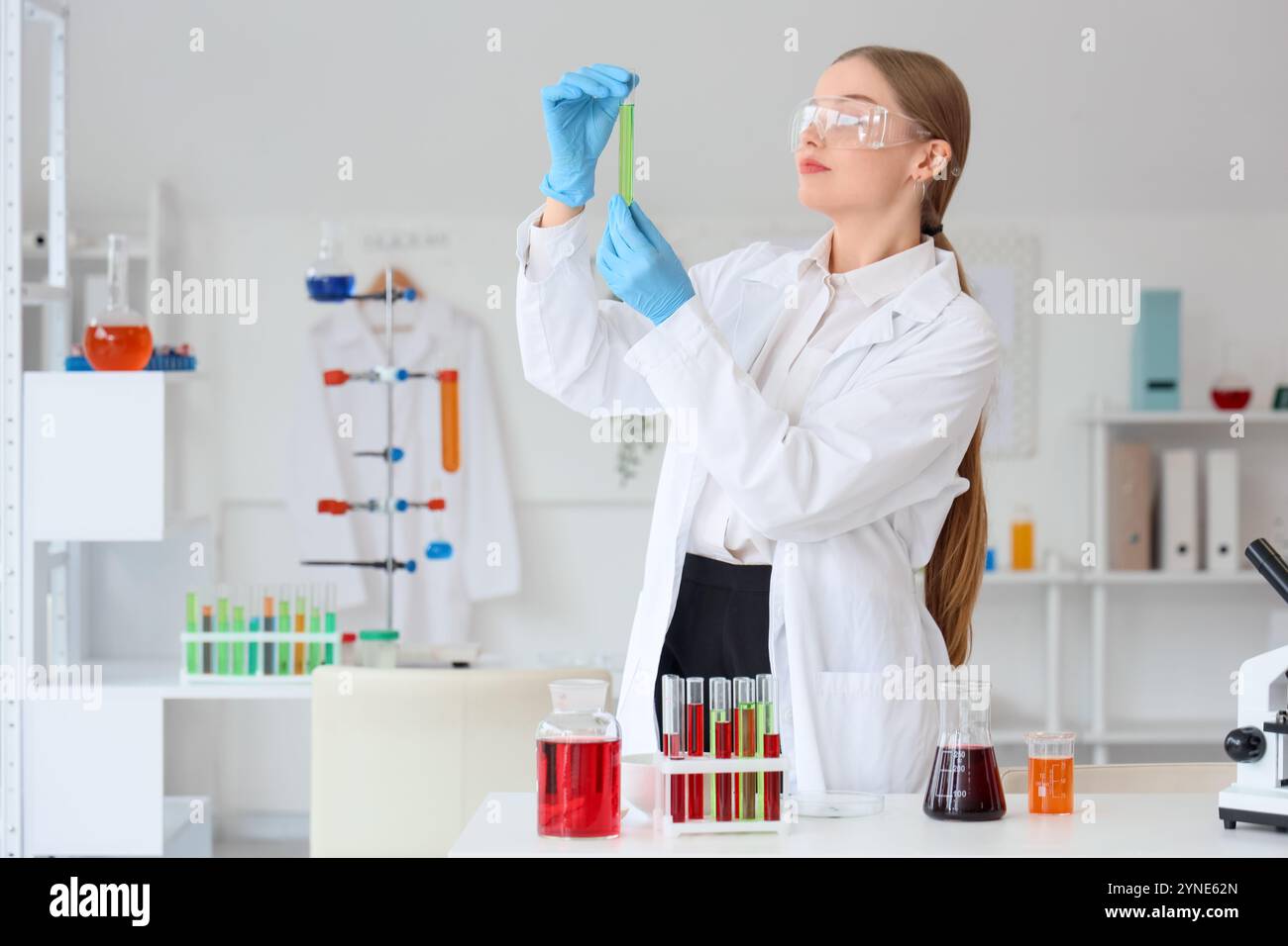 Female chemist studying test tube hi-res stock photography and images ...