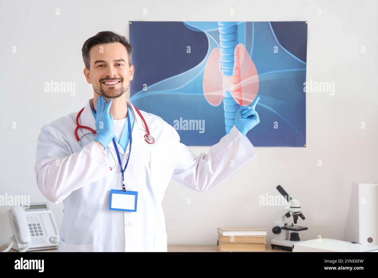 Male endocrinologist pointing at picture of thyroid gland in clinic ...