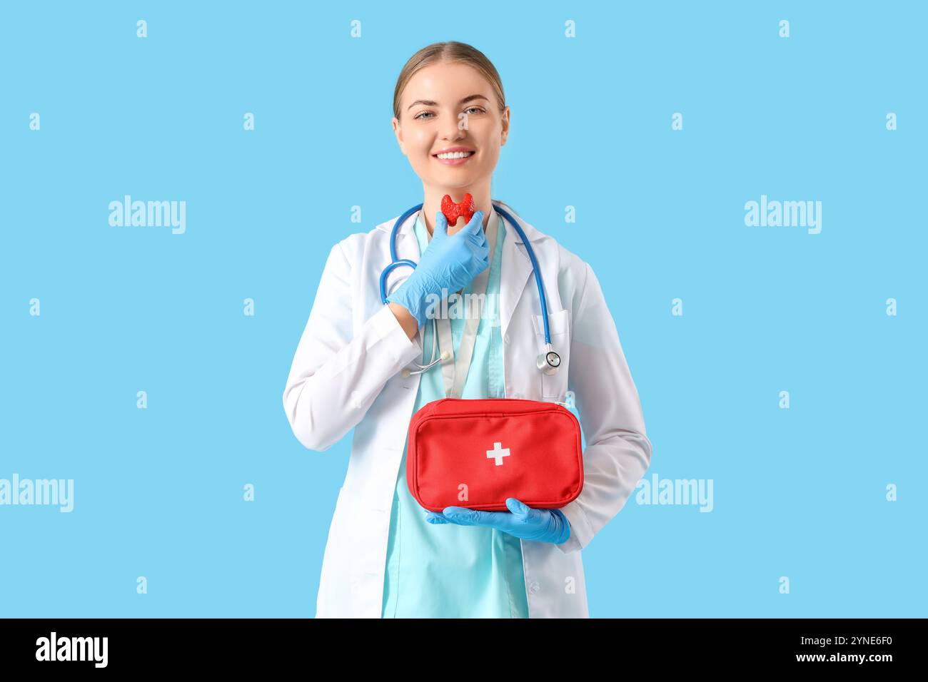 Female endocrinologist with thyroid gland model and first aid kit on ...