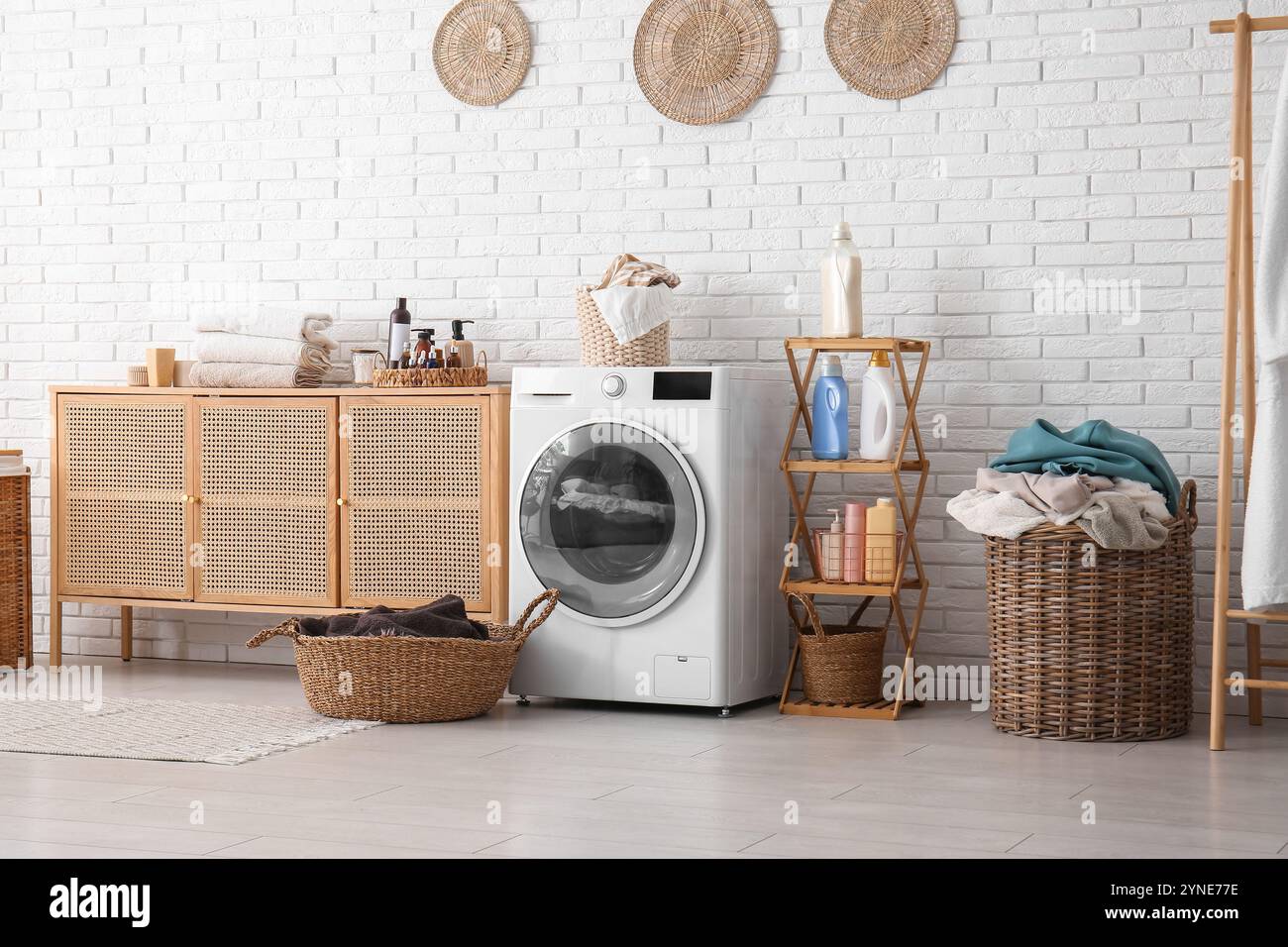 Modern washing machine, baskets, shelving unit with laundry detergent ...