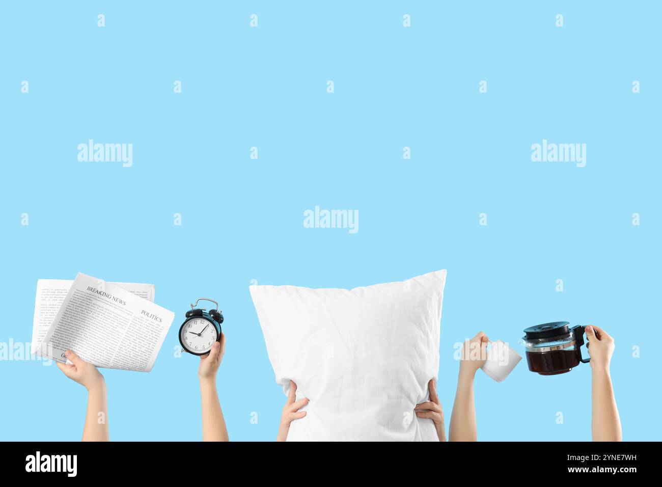Female hands with morning newspaper, alarm clock, pillow and coffee on ...