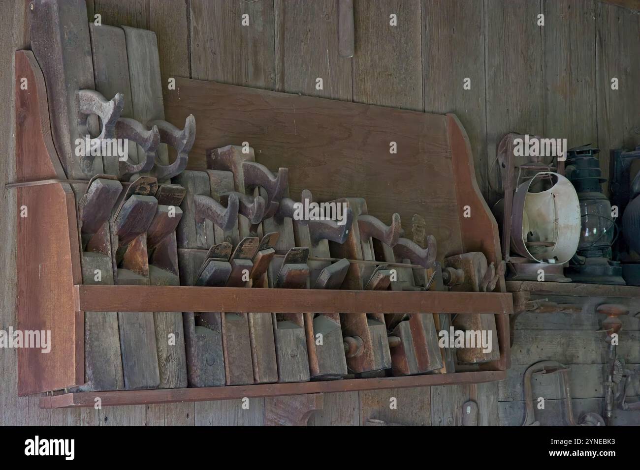 Rack of antique wood planes on wall of old barn Stock Photo - Alamy