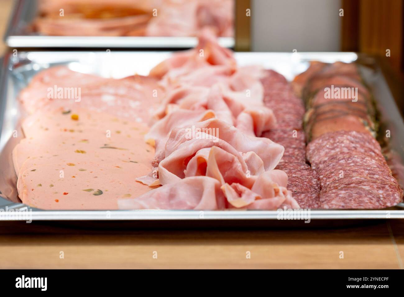 Thinly sliced shaved Ham meat on serving plate, buffet breakfast ...