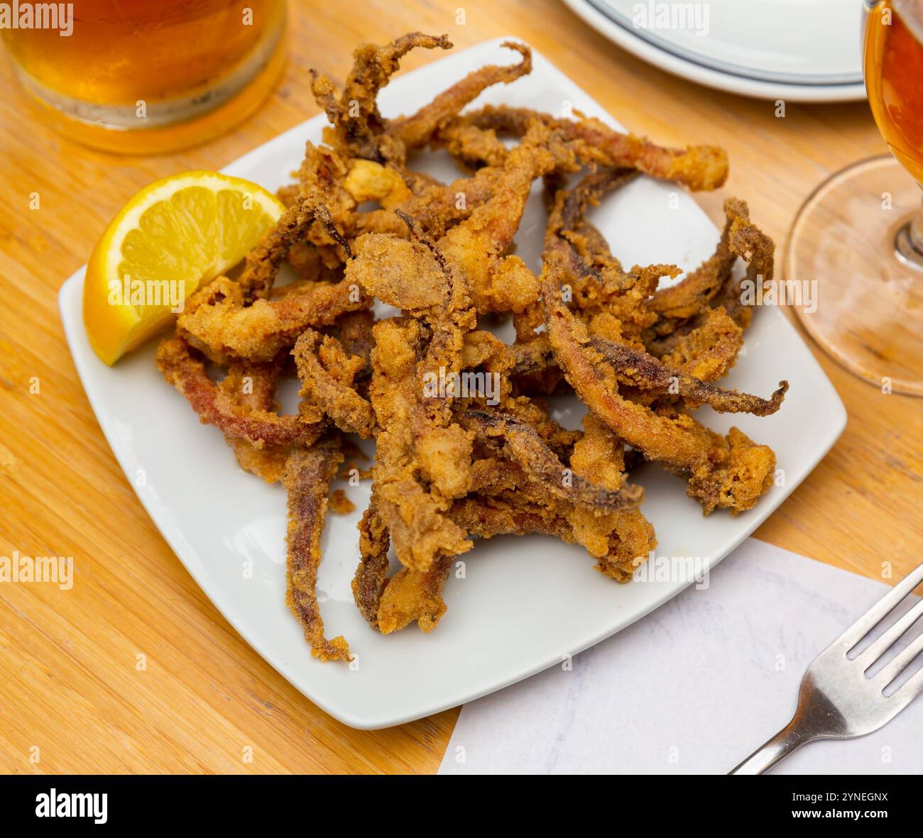 Delicious dish of grilled squid legs in batter Stock Photo - Alamy