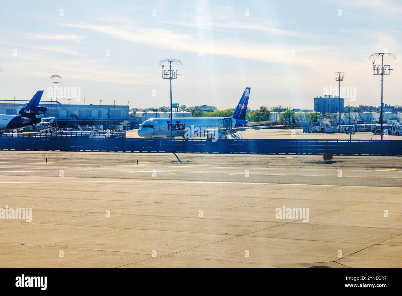 FedEx cargo airplanes parked at airport terminal under bright sunny sky ...