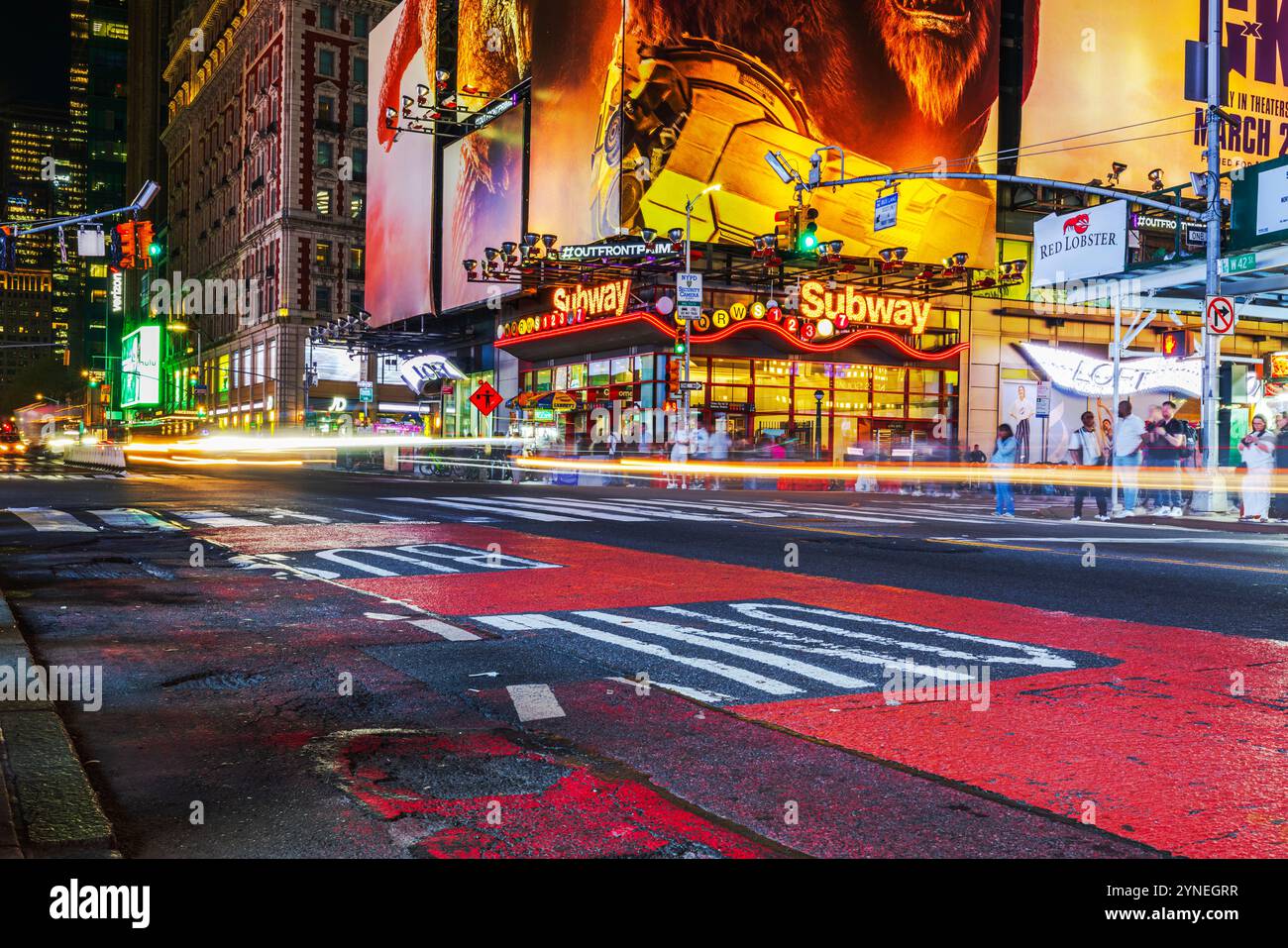 Times Square at night with glowing billboards, illuminated subway ...