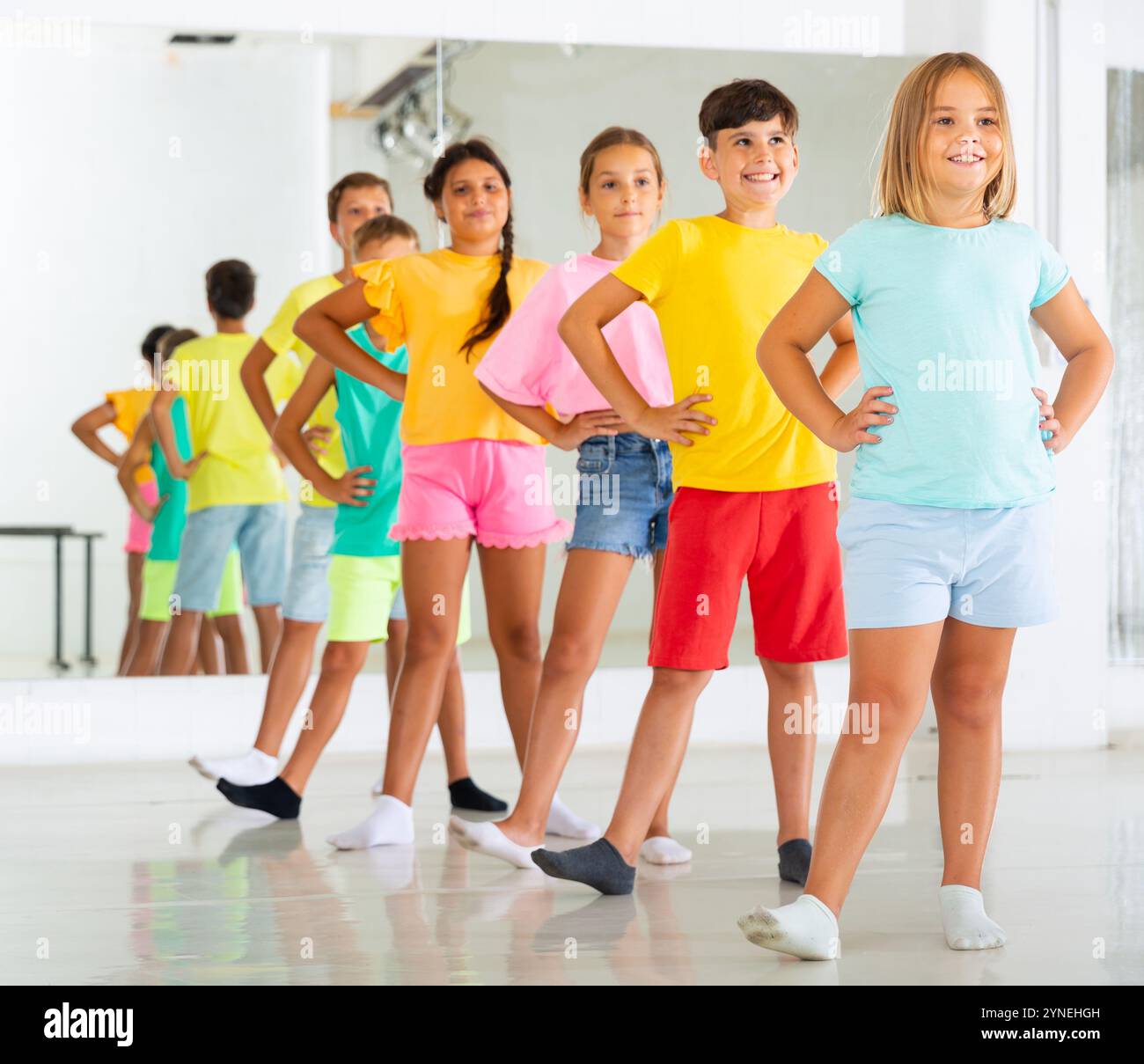 Cheerful tweens lined up one after another practicing folk dance Stock ...