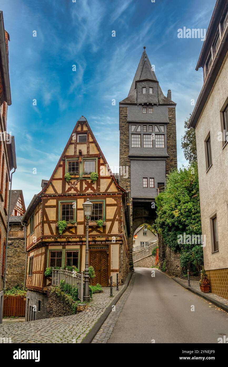 Restored medieval city gate and city walls, half timbered houses in the ...