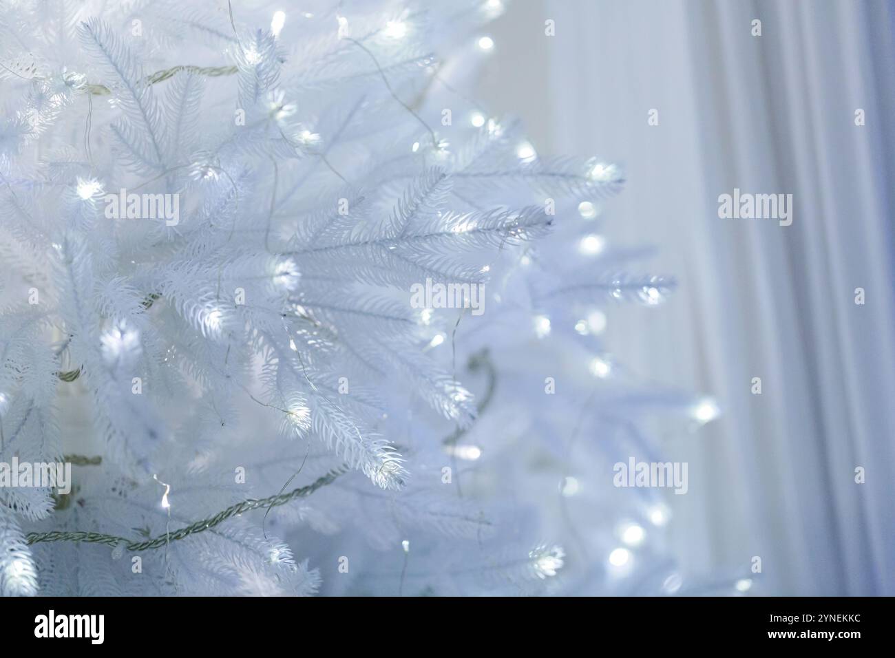 Frosted White Christmas Tree with Soft Lights Stock Photo - Alamy