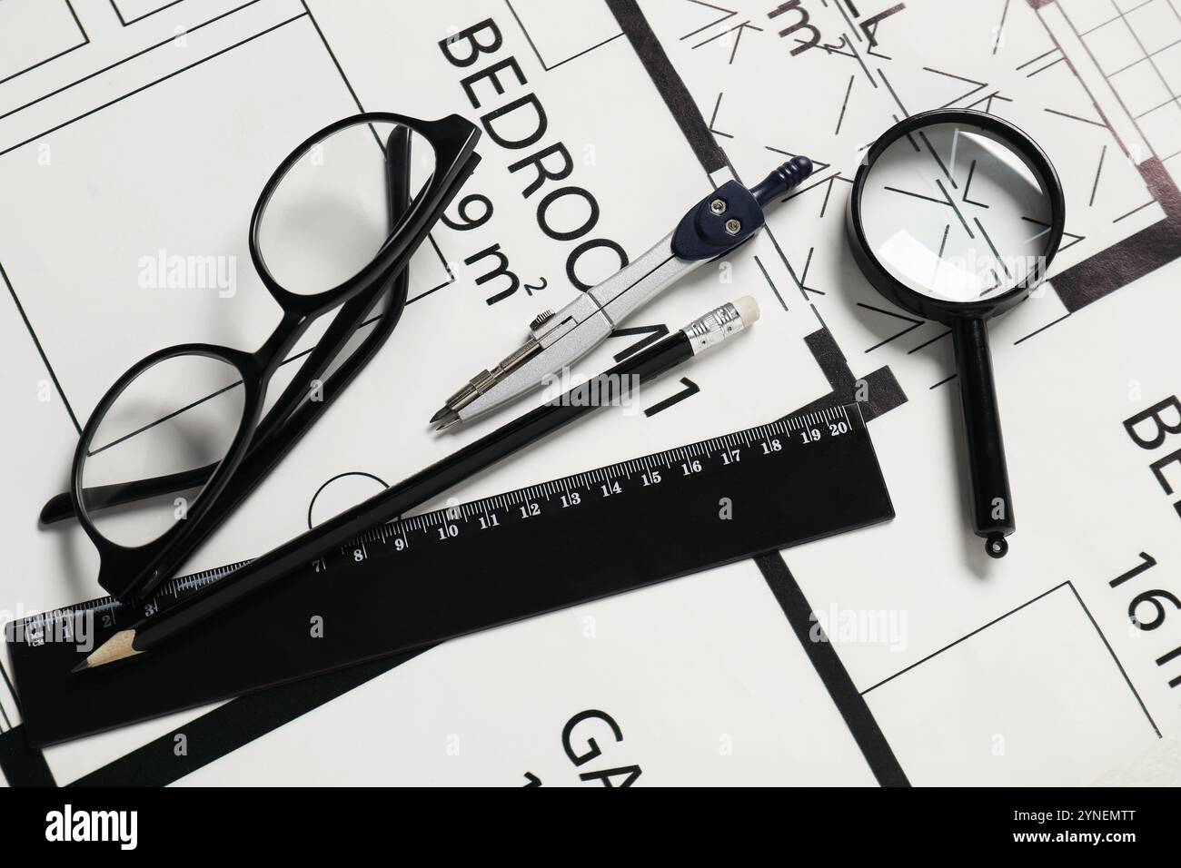 Ruler, glasses, dividers, magnifying glass and pencil on different ...
