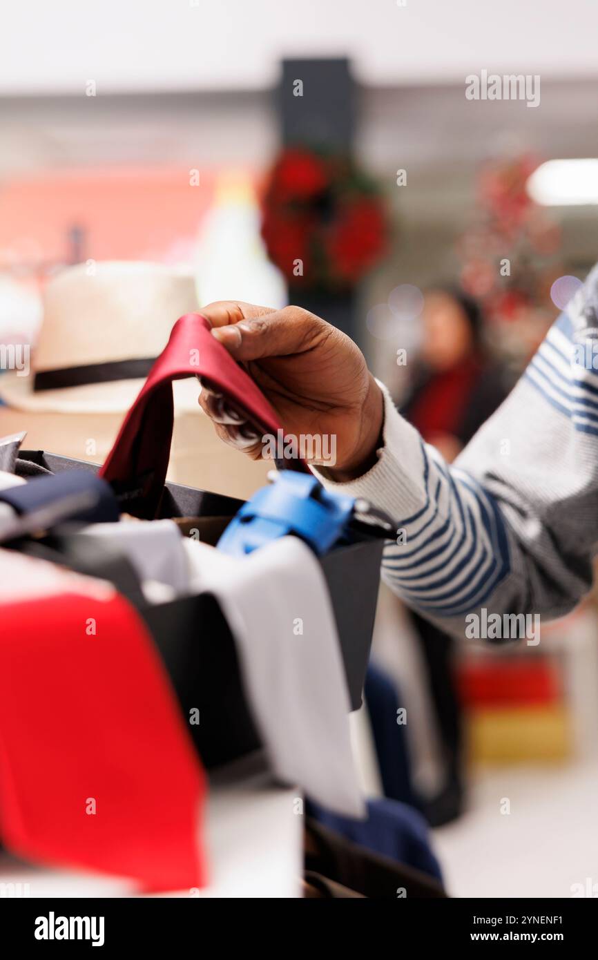 Worker fixing ties and accessories in box for retail store display ...
