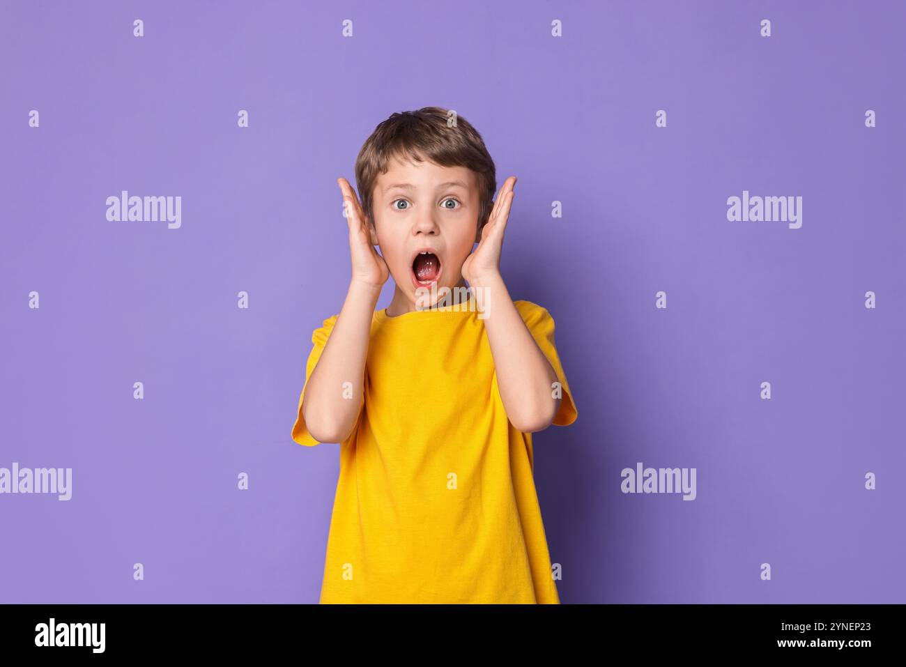 Portrait of scared little boy on violet background Stock Photo - Alamy