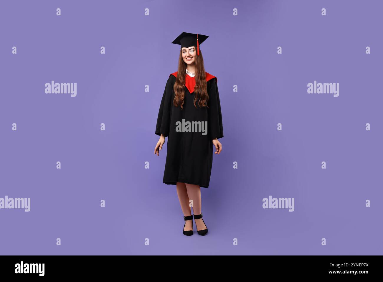 Happy student after graduation on violet background Stock Photo - Alamy