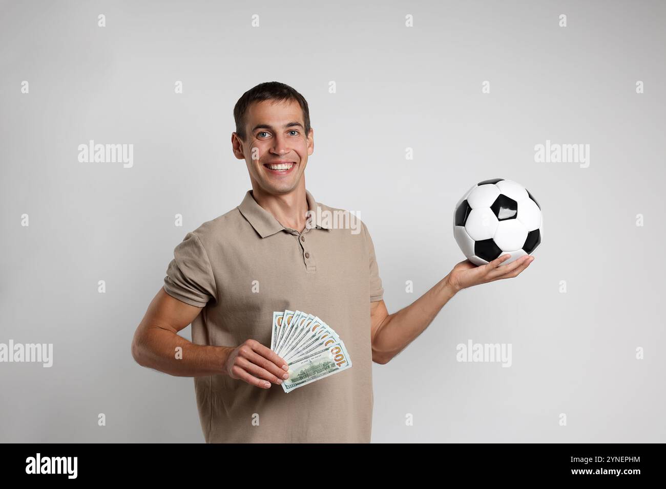 Happy man with money and soccer ball on white background Stock Photo ...