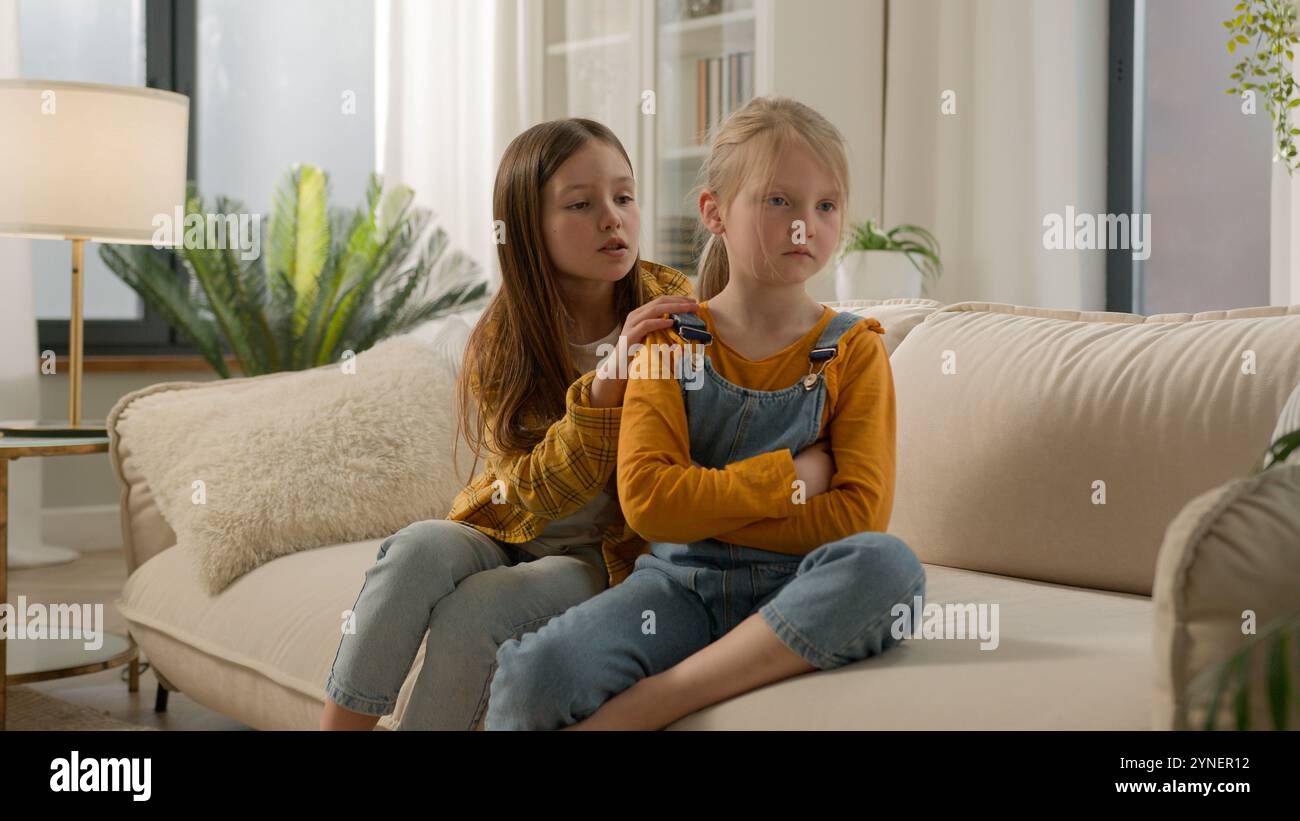 Two little Caucasian kids children siblings daughters girls argument ...