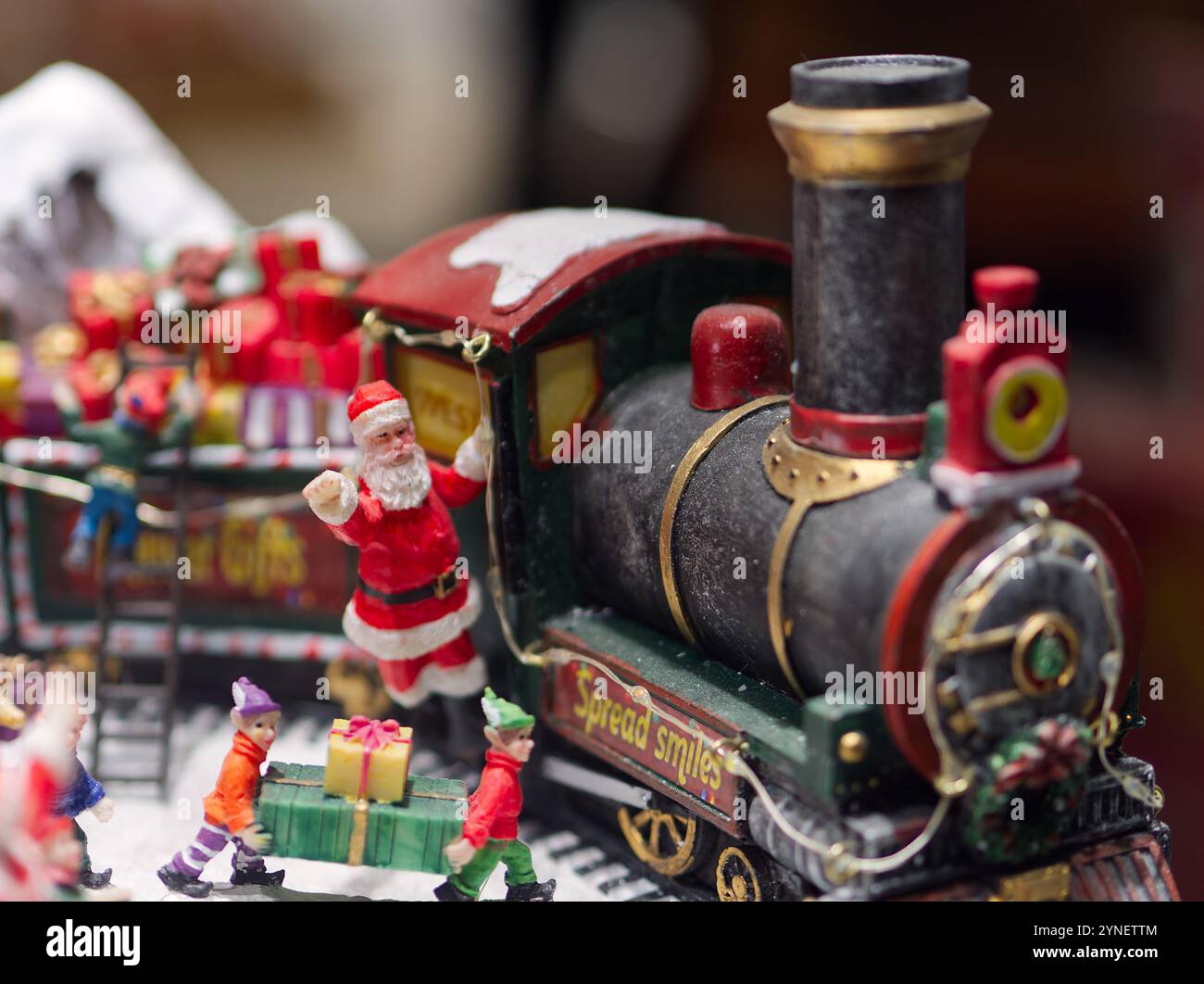 Miniature Christmas scene close-up with Santa Claus figurine waving ...