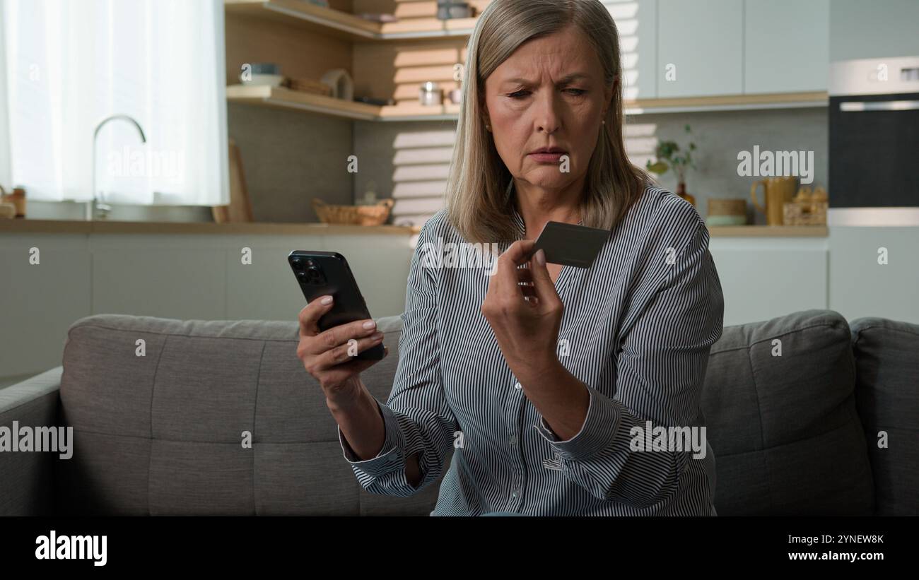 Angry confused senior Caucasian woman mature elderly female mother hold ...