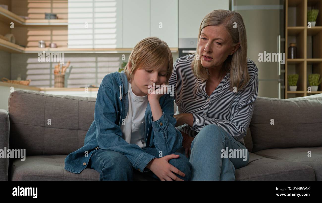 Strict angry elderly senior Caucasian woman grandmother punishing ...