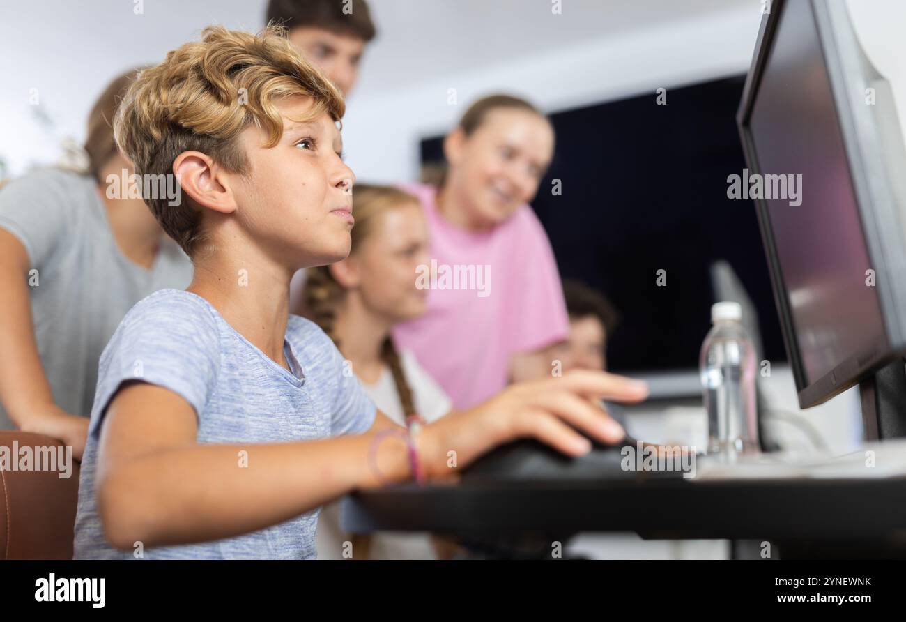 Boy student learning to work on computer in classroom Stock Photo - Alamy