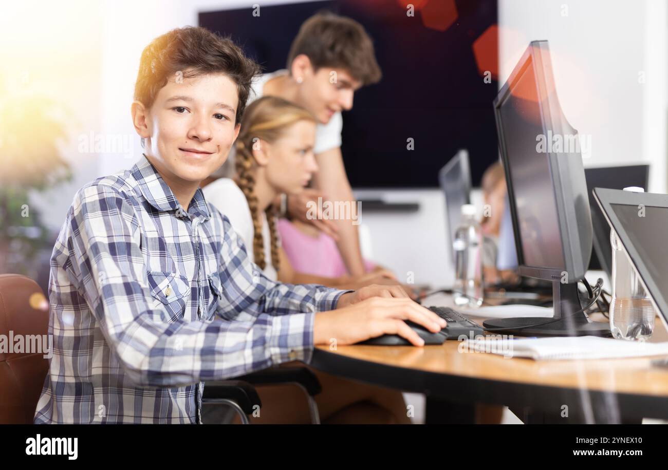 Boy student learning to work on computer in classroom Stock Photo - Alamy