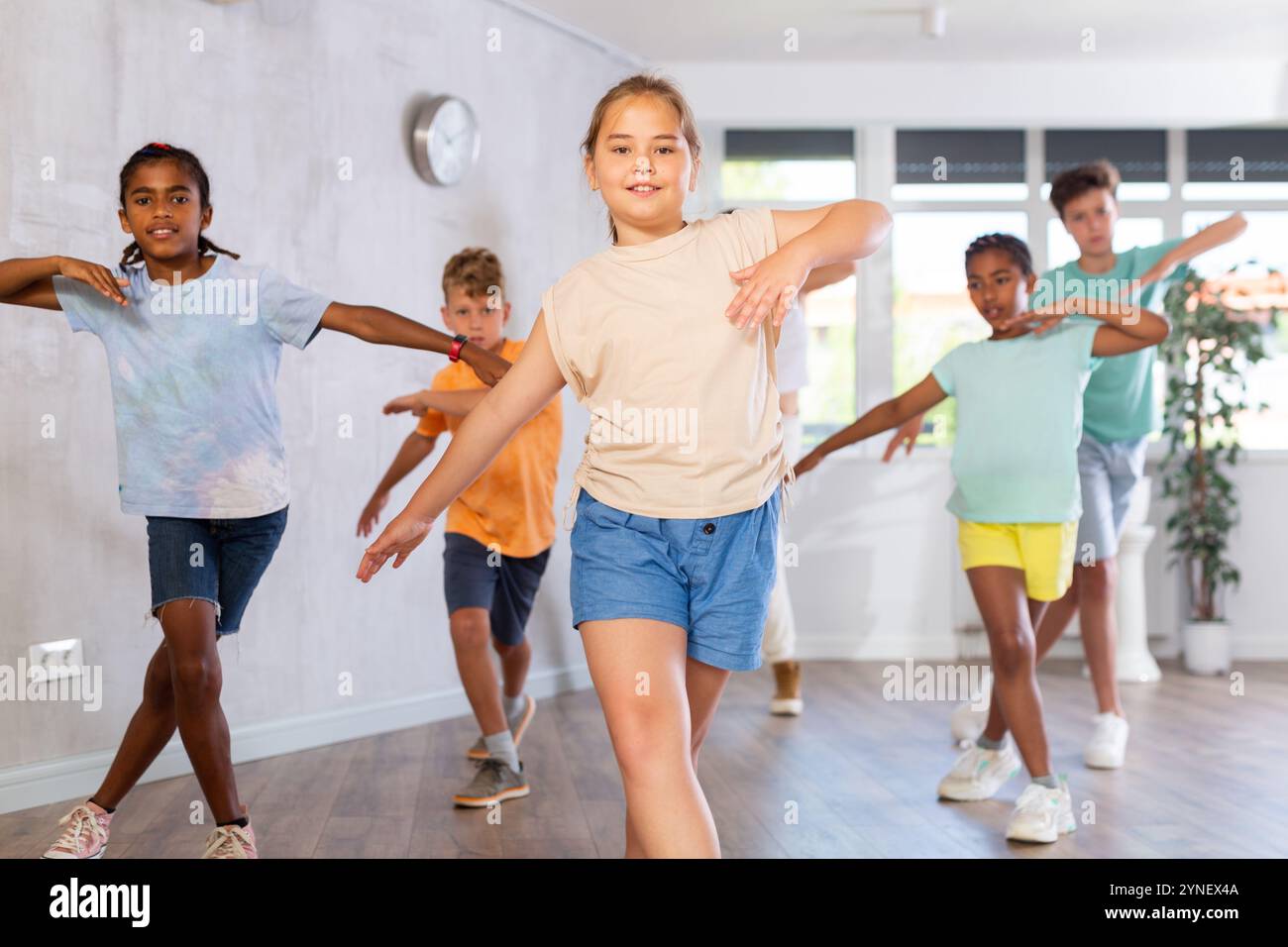 Energetic tween girl practicing vigorous movements in children dance ...