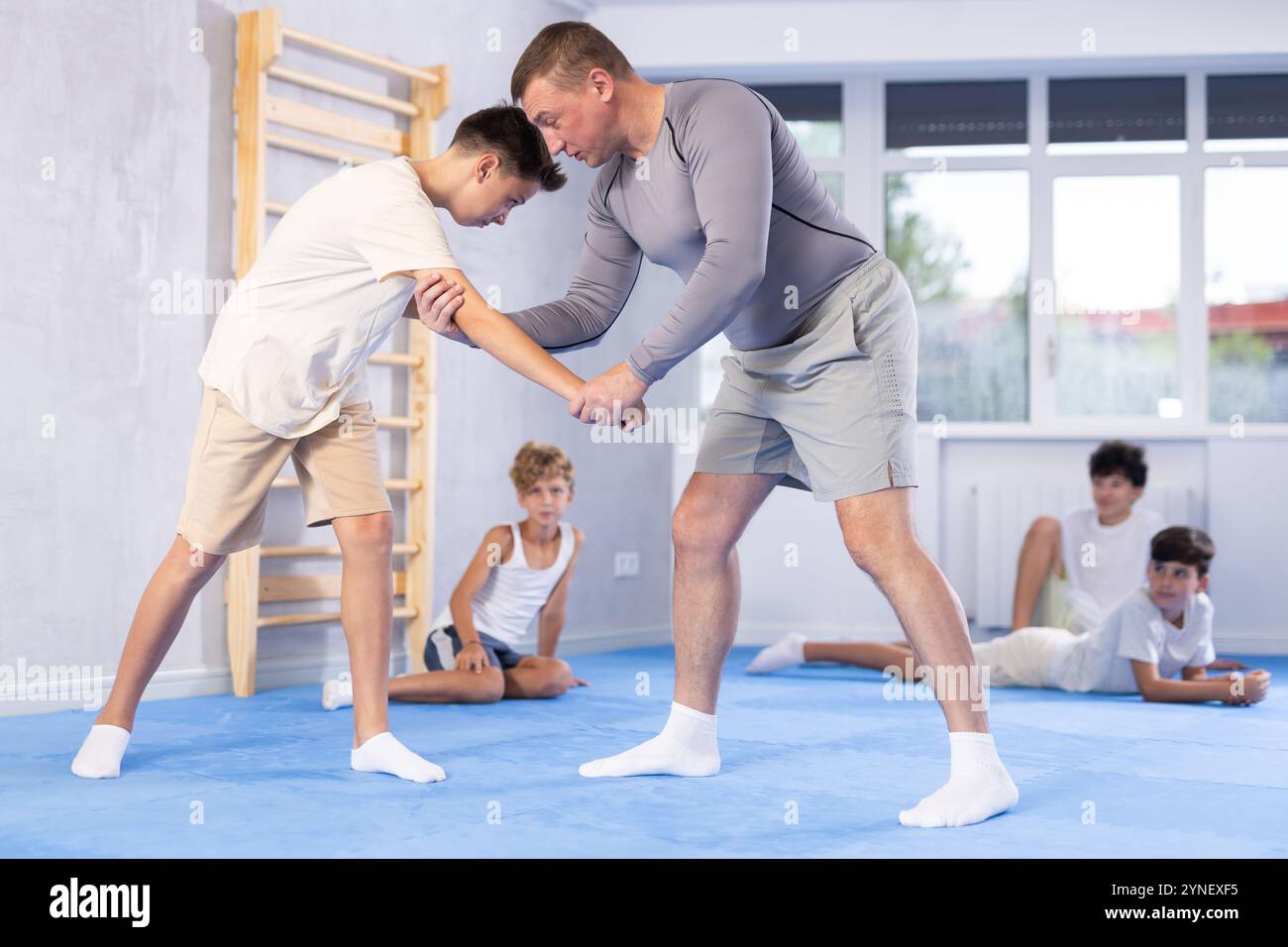 Judo teenager kids and trainer engaged in judo class in dojo at gym ...