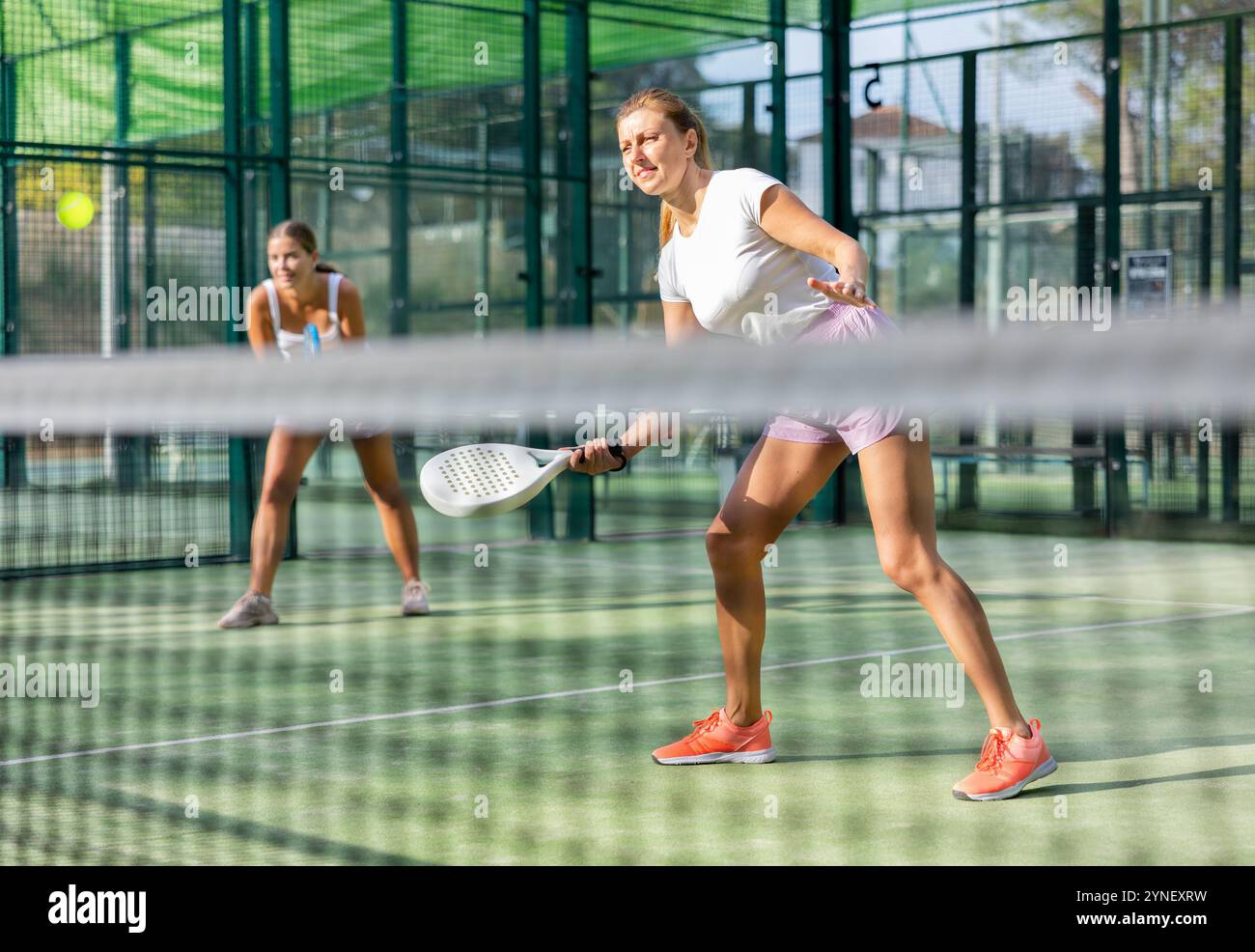 Two women tennis players playing padel Stock Photo - Alamy
