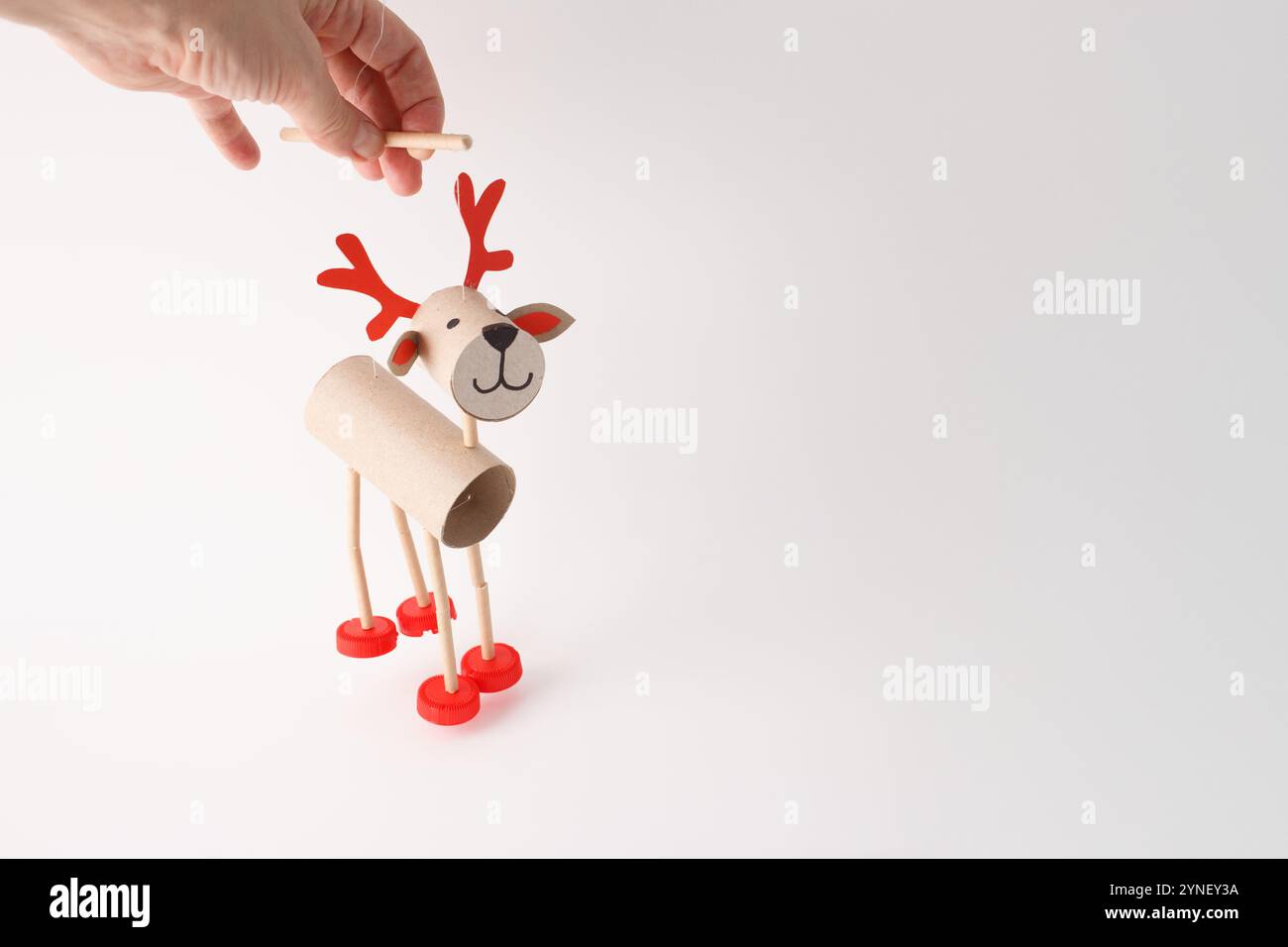 DIY reindeer puppet made from cardboard tubes, plastic caps, and paper ...
