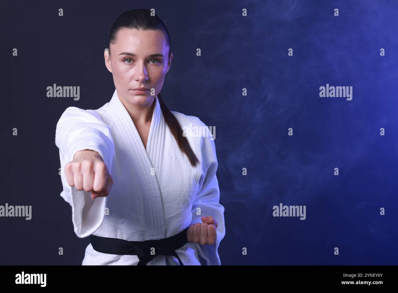 Karate fighter in kimono on dark blue background, space for text Stock ...